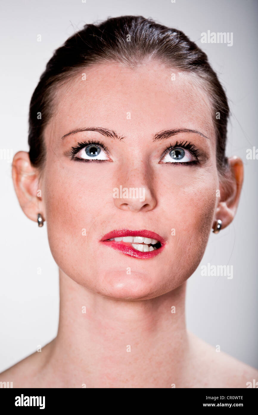 Portrait of a young woman looking sceptical Stock Photo - Alamy