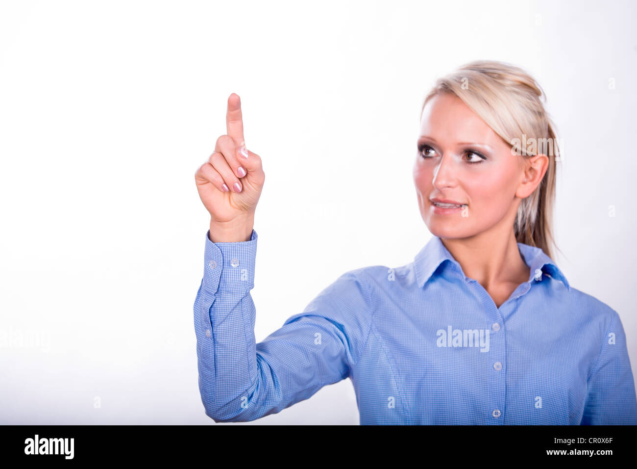 Young woman writing, pointing with her forefinger Stock Photo - Alamy