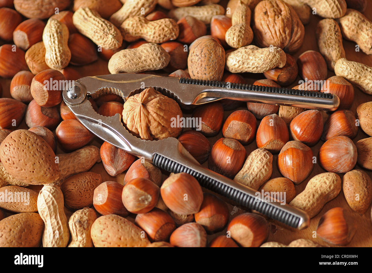 Mixed nuts with a nutcracker Stock Photo - Alamy