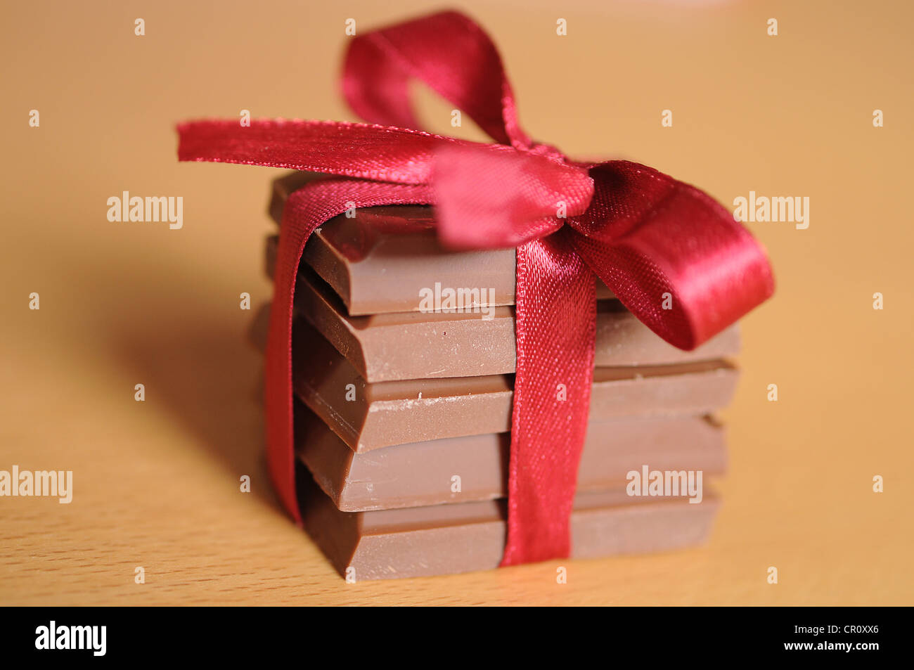 Stack of chocolate tied with ribbon in a bow Stock Photo - Alamy