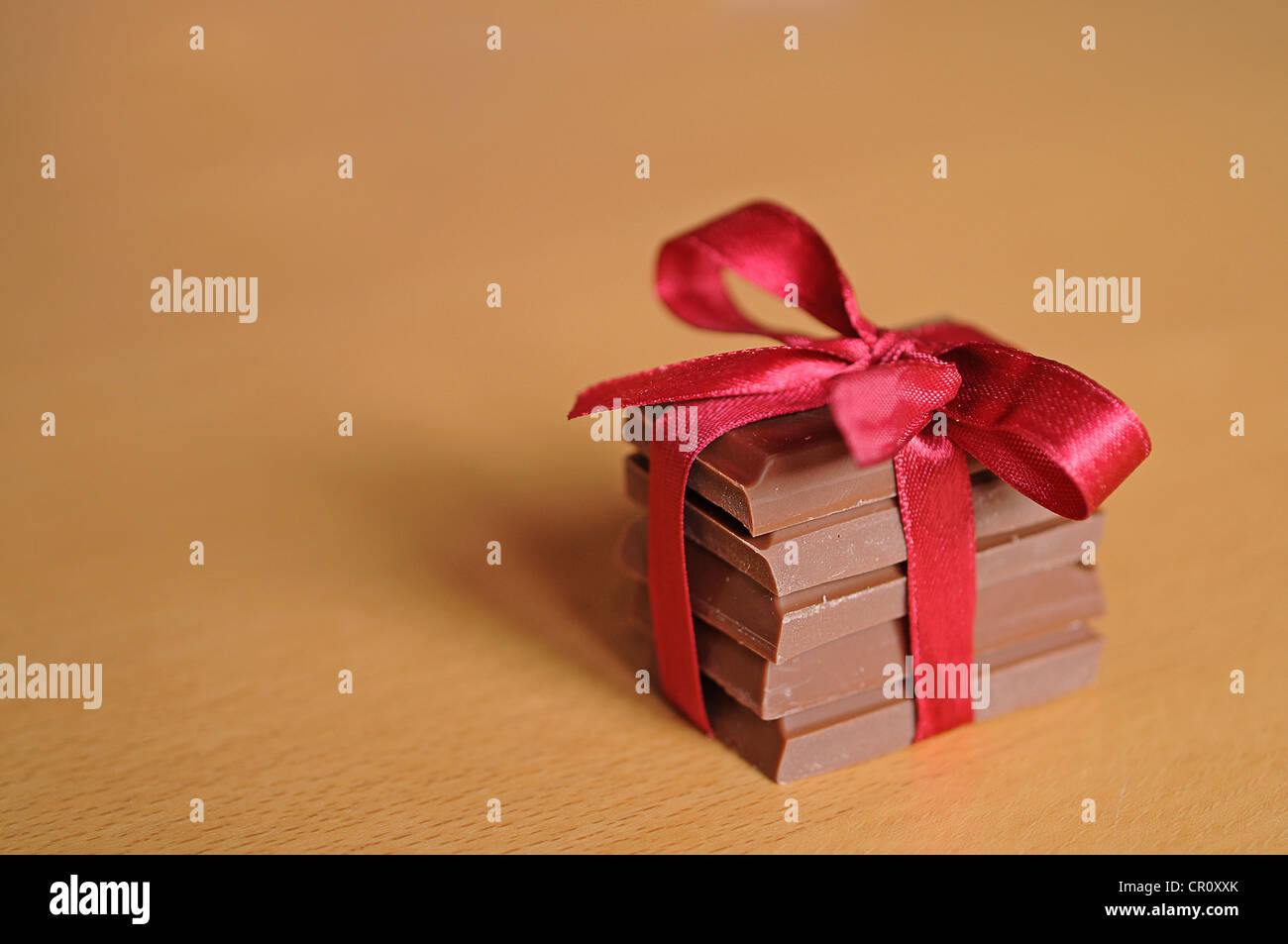Stack of chocolate tied with ribbon in a bow Stock Photo - Alamy