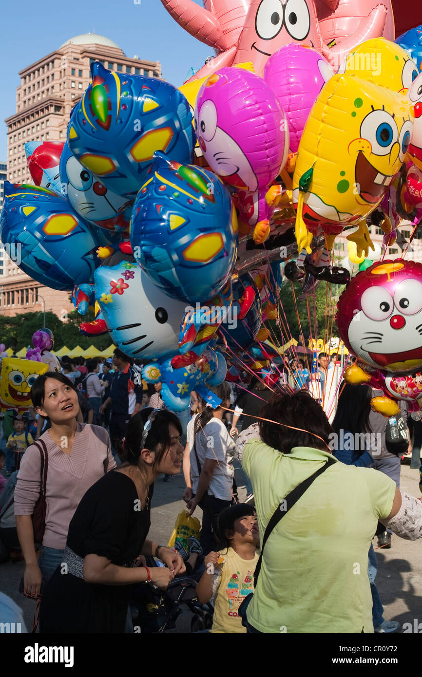 Taiwan, Taipei, funfair, salesman selling helium balloons with ...