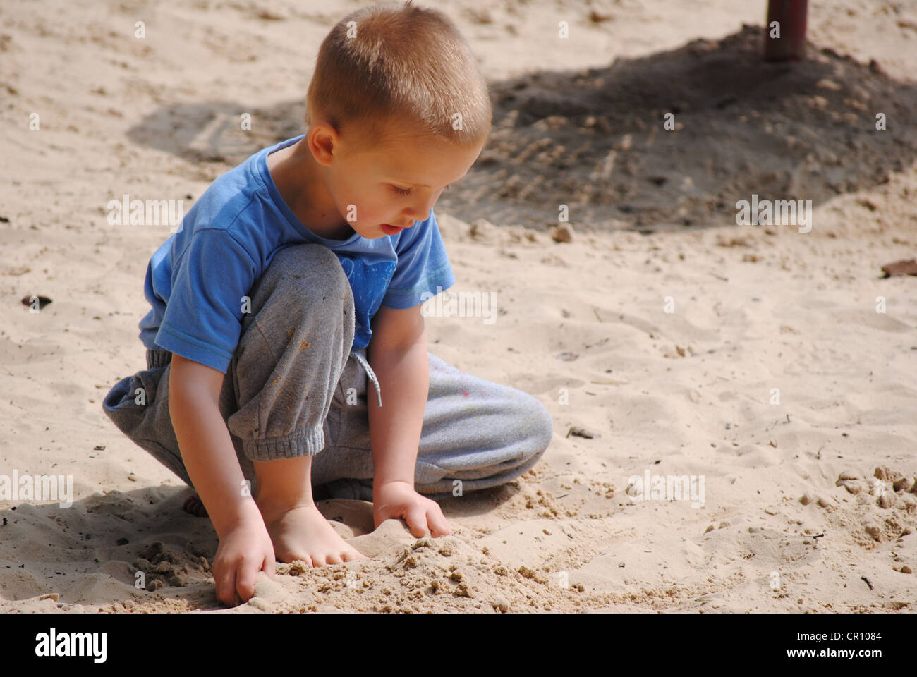 little boy playing with sand Stock Photo - Alamy