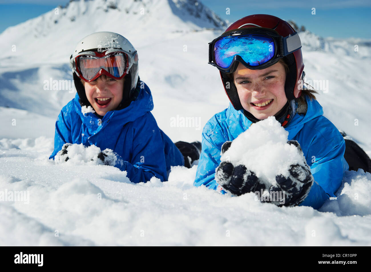 Children making snowballs on mountain Stock Photo - Alamy