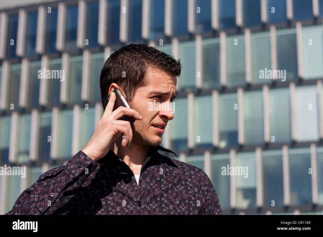 Handsome young man calling Stock Photo - Alamy