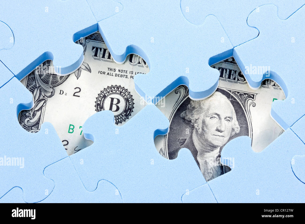 Hidden assets concept. Blue puzzle on one dollar bill Stock Photo - Alamy