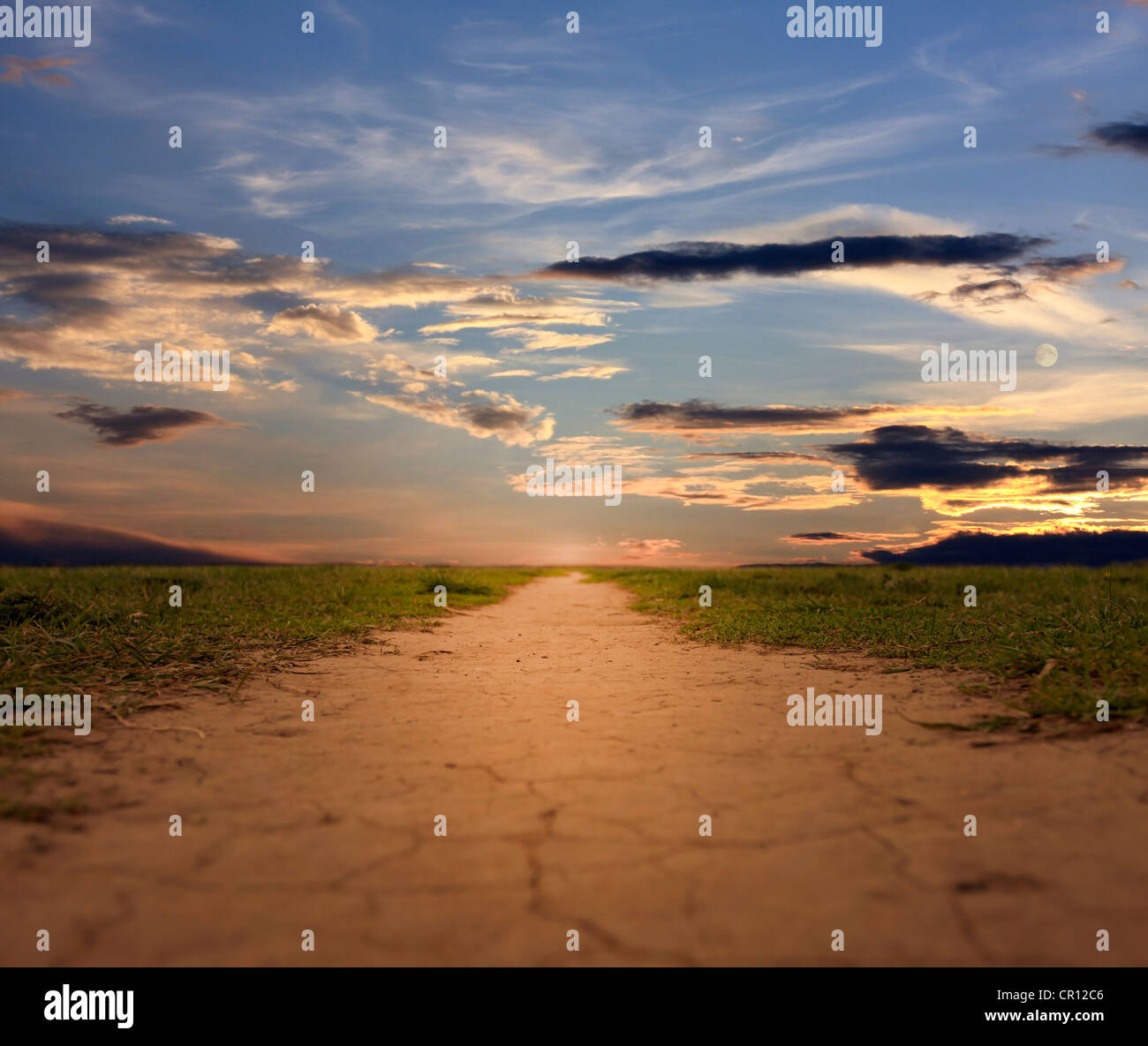 Dry dirty road on the field and sunset Stock Photo - Alamy