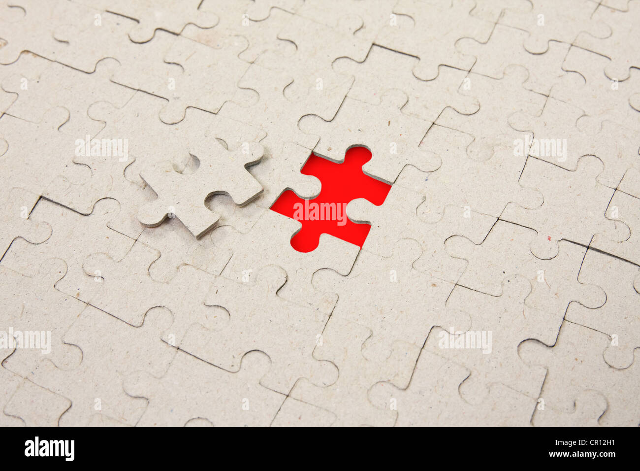 papper puzzle background with one red piece missing Stock Photo - Alamy
