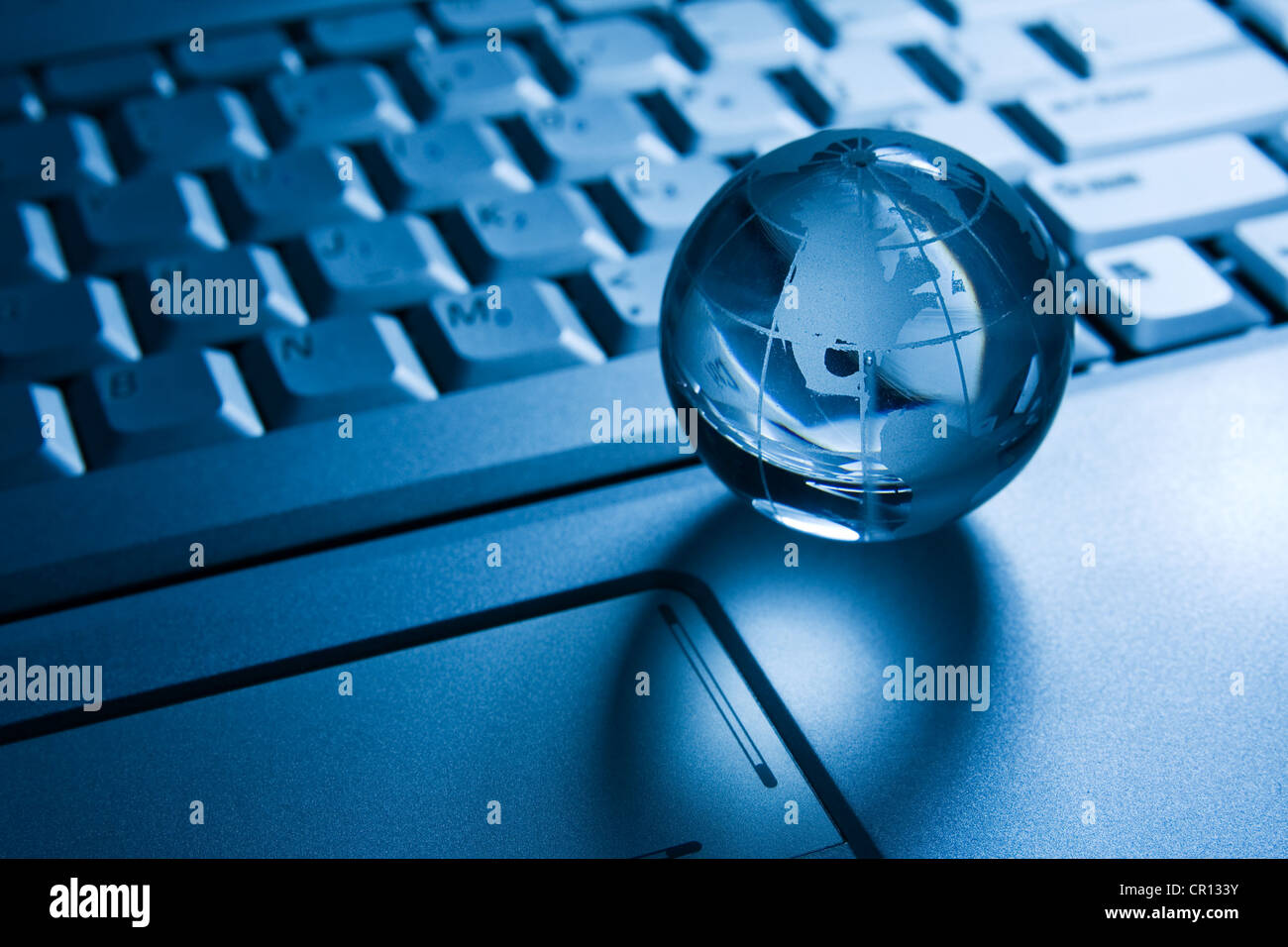 globalization concept. transparent globe on a laptop keyboard Stock ...