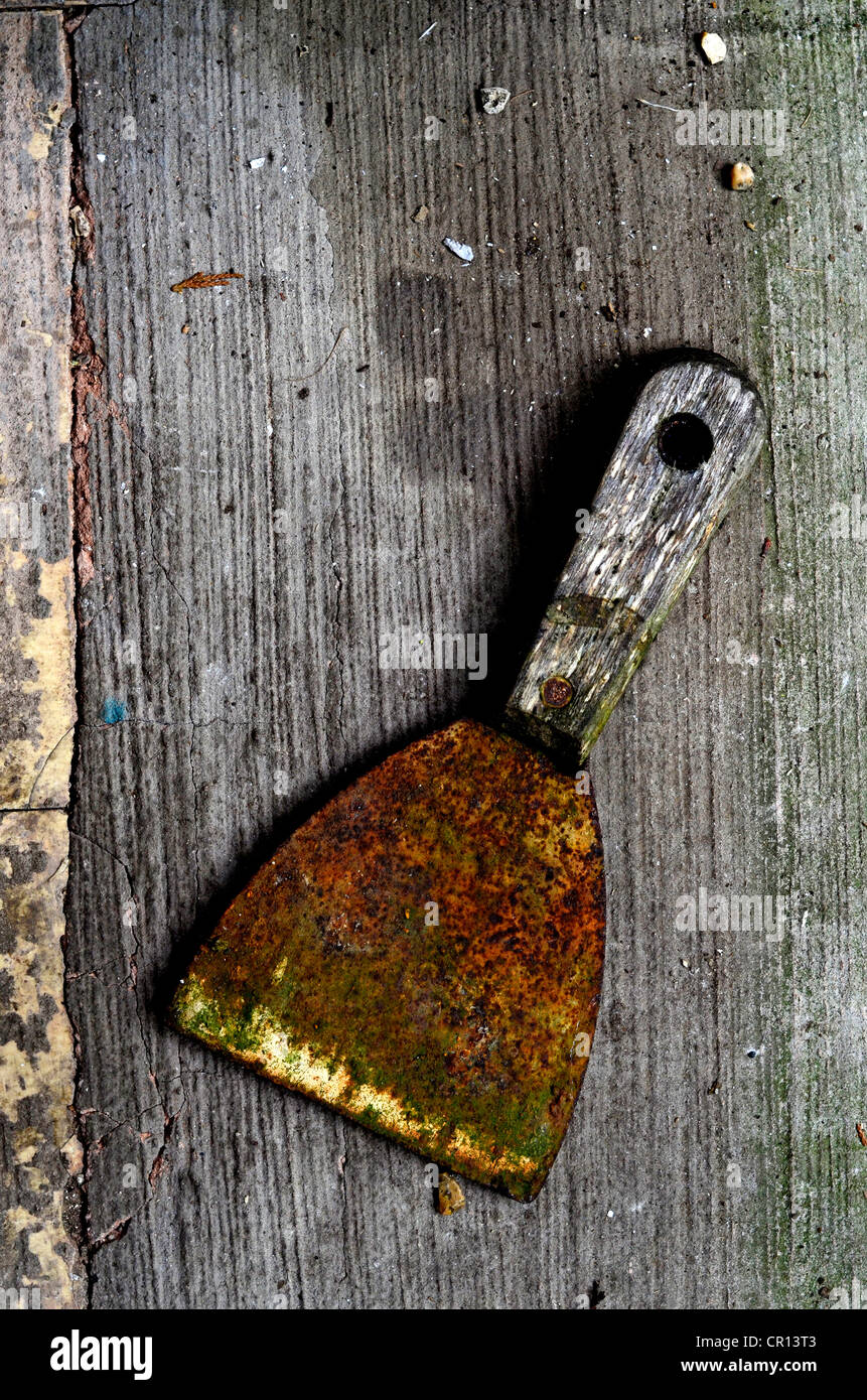 Old paint scraper on textured surface Stock Photo - Alamy