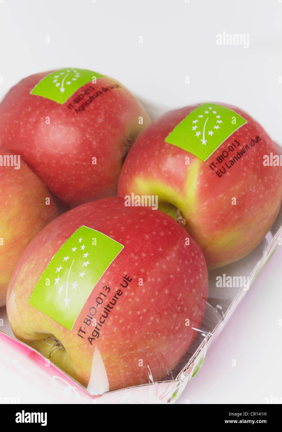 Wrapped pink lady organic certified apples in white background Stock ...