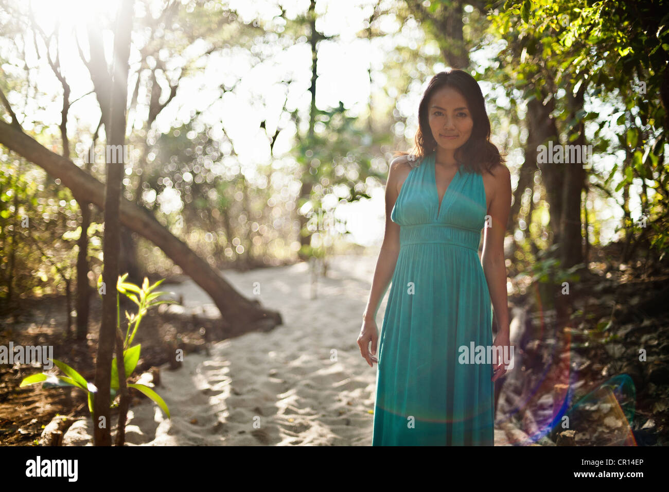 Woman walking in sandy forest Stock Photo - Alamy