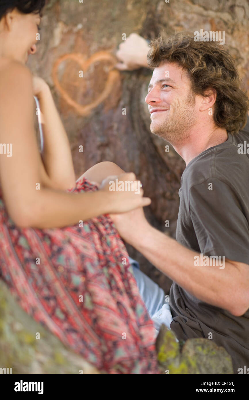 Couple carving love heart in tree hi-res stock photography and images ...