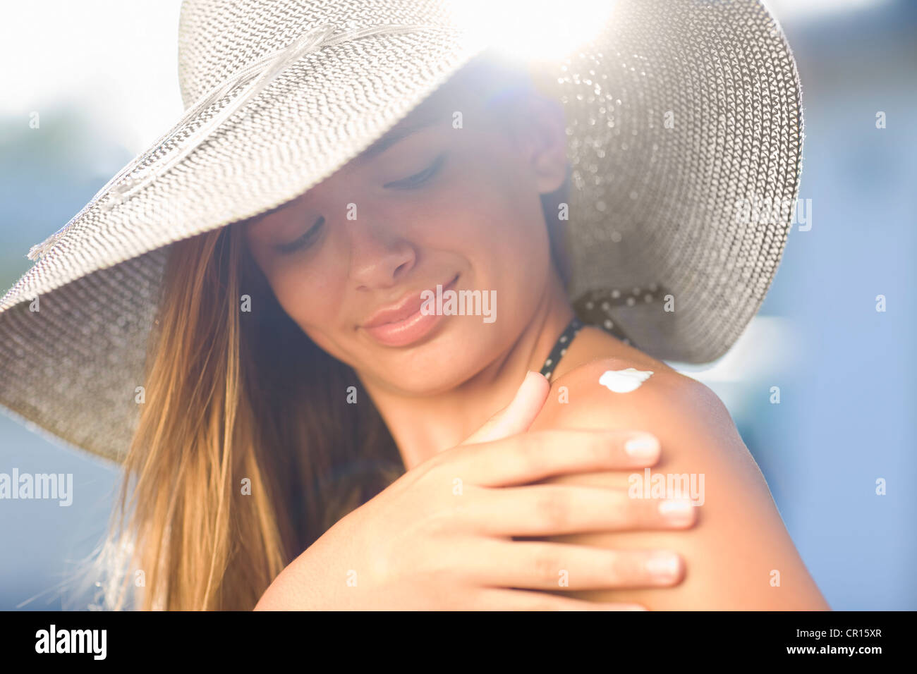 Teenage girl applying sunscreen outdoors Stock Photo - Alamy