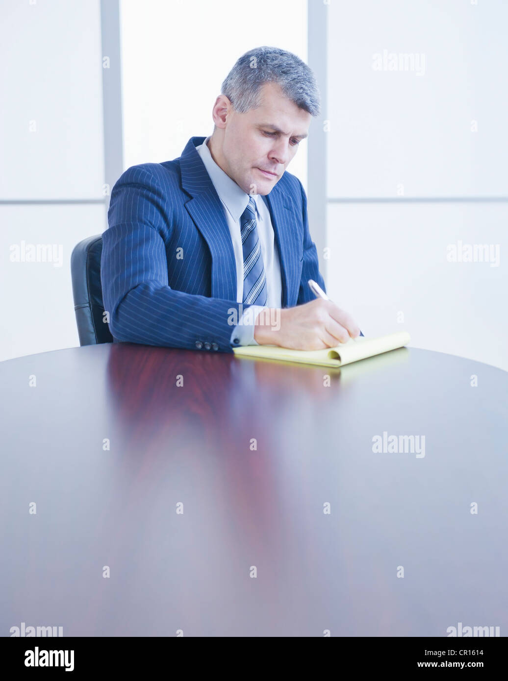 Portrait confident businessman table hi-res stock photography and ...