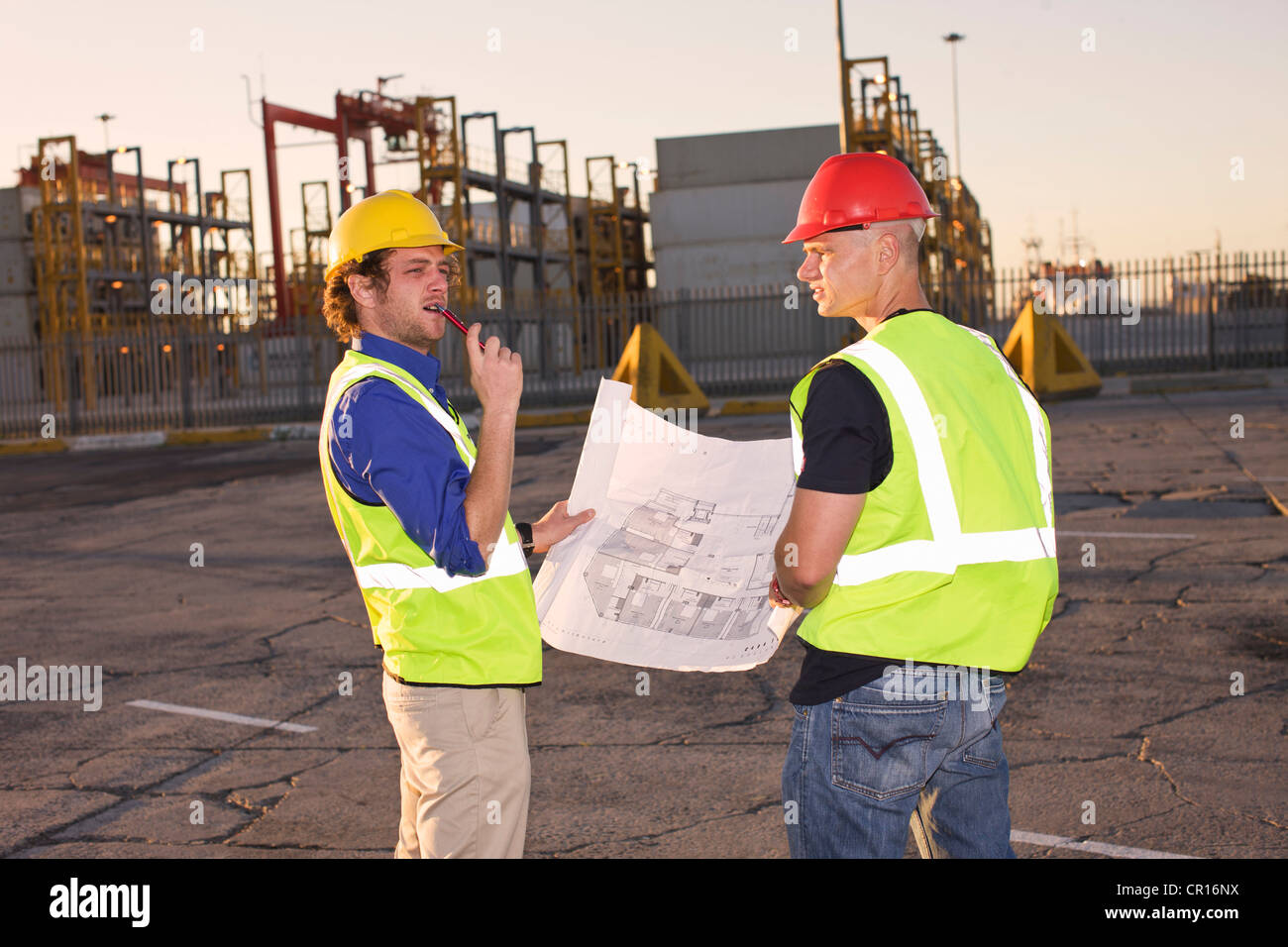 Construction workers reading blueprint Stock Photo - Alamy