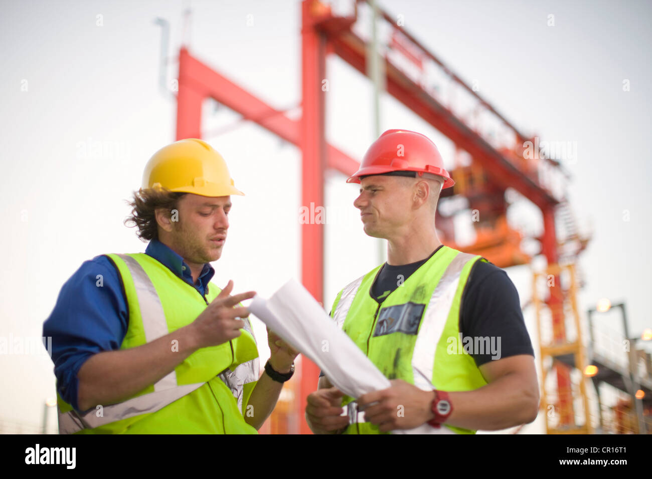 Construction workers talking on site Stock Photo - Alamy