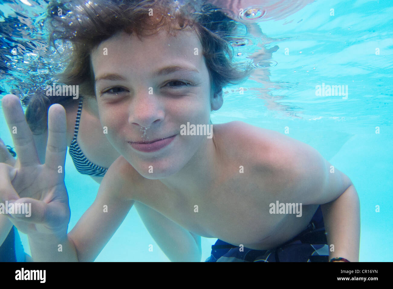 Smiling boy playing in pool Stock Photo - Alamy