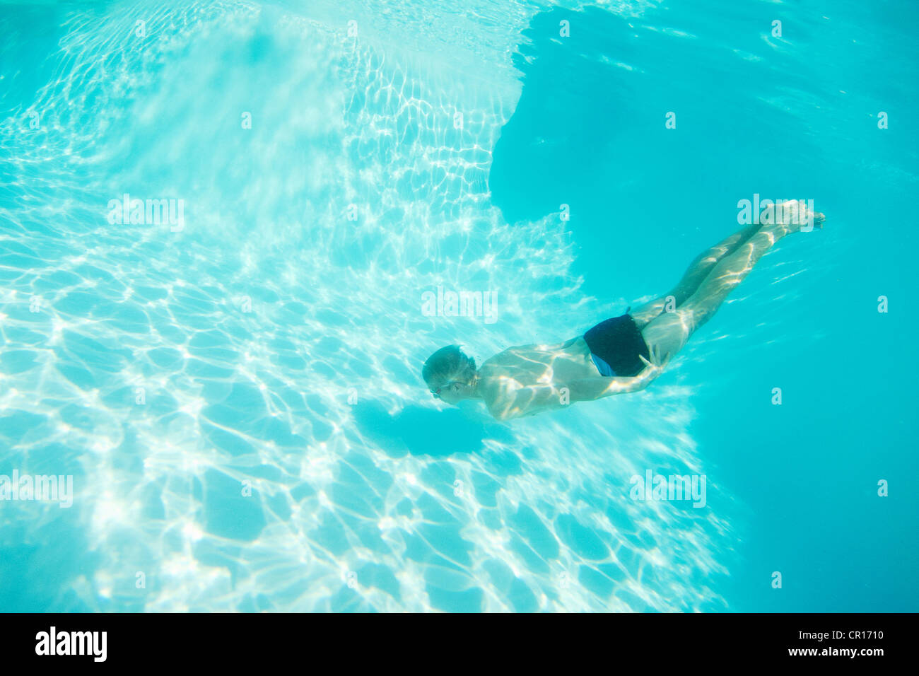 Boy in goggles swimming in pool Stock Photo - Alamy