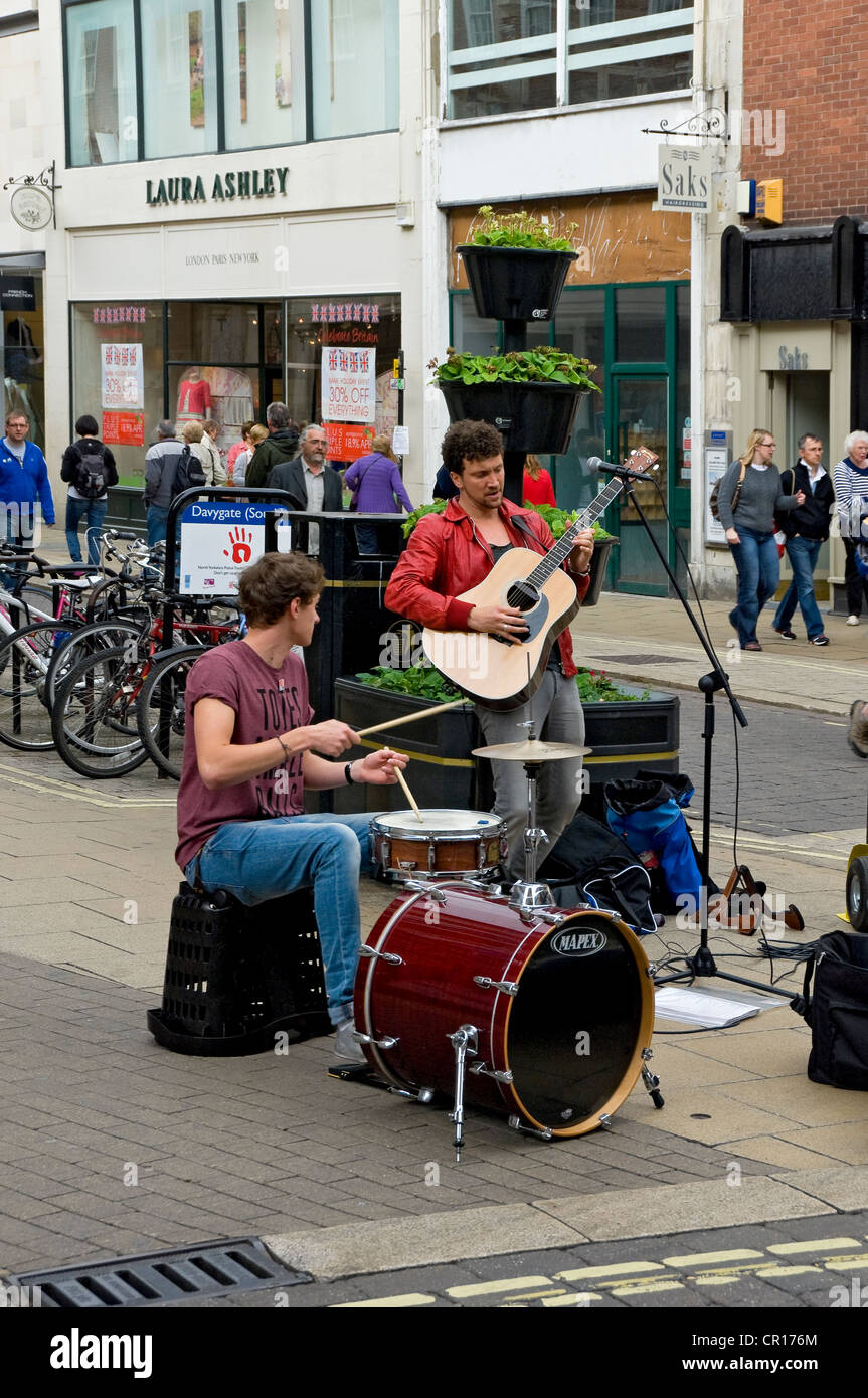 Group of young men playing music street musicians performing in the ...