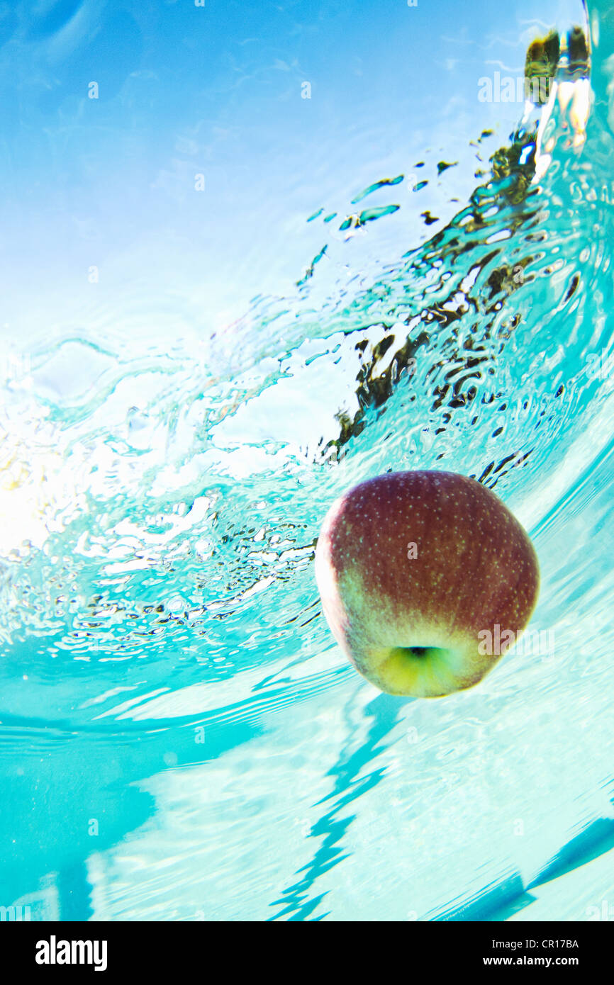 Apple floating in swimming pool Stock Photo - Alamy
