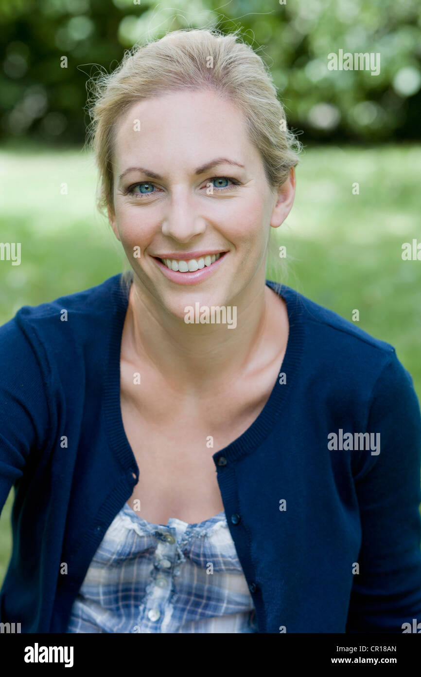 Smiling woman standing outdoors Stock Photo - Alamy