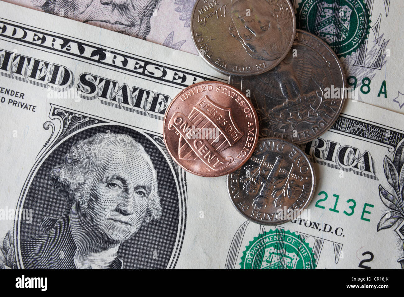 Close-up of dollar banknotes and coins Stock Photo - Alamy