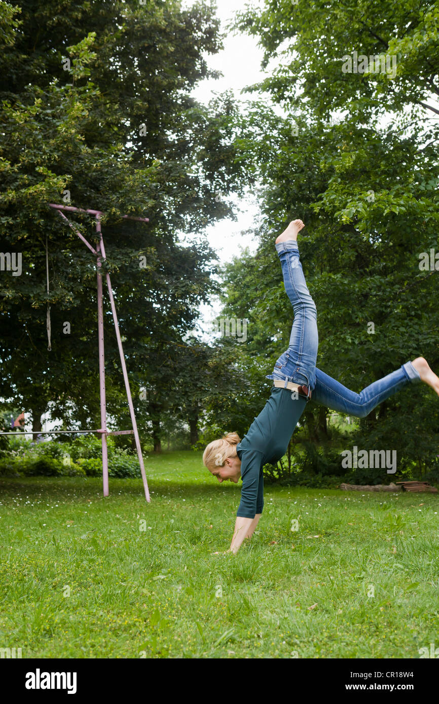 Woman playing in backyard Stock Photo - Alamy