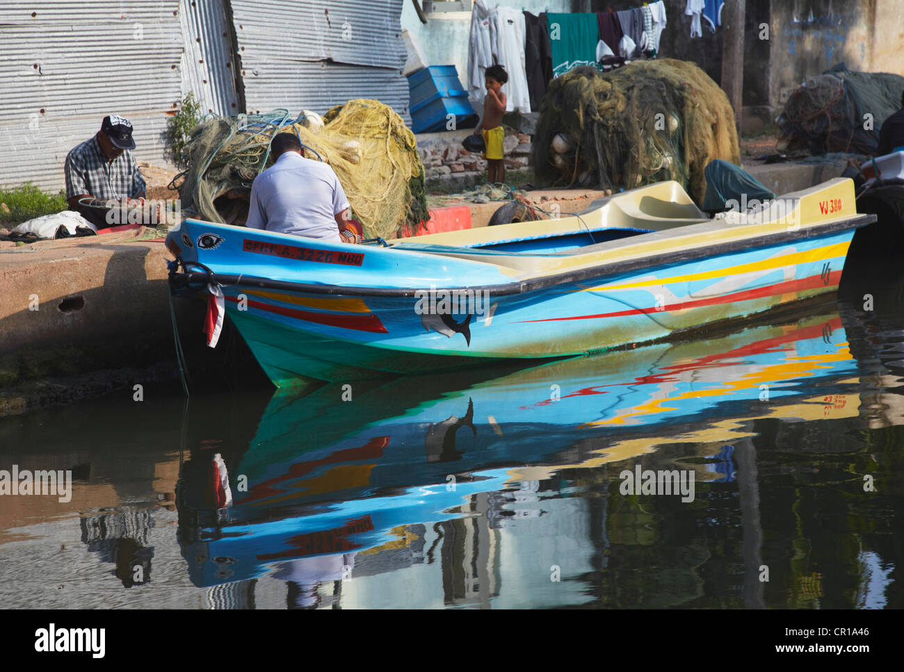 Fishermen fixing nets along Hamilton Canal (old Dutch canal), Negombo ...