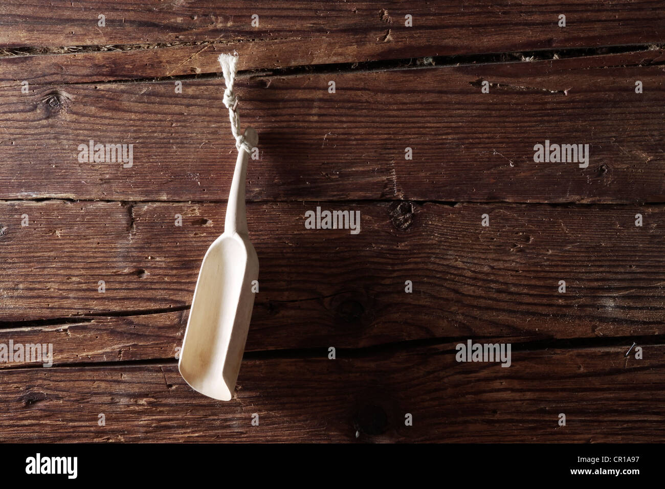 Old wooden scoop hanging on a rustic wooden wall Stock Photo - Alamy