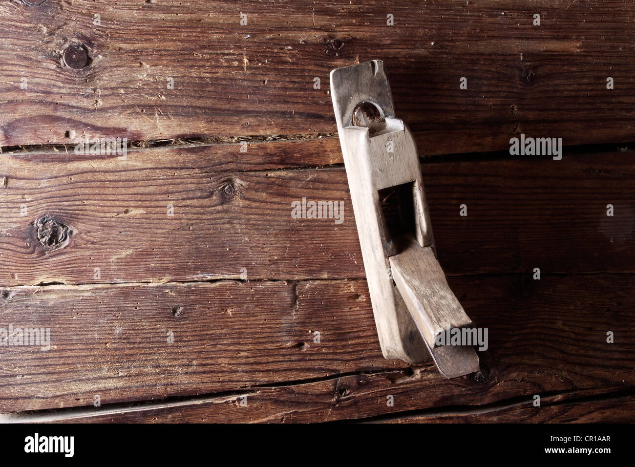 Old wood plane hanging on a rustic wooden wall Stock Photo - Alamy