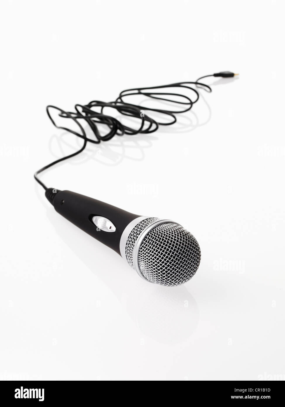 Studio shot of microphone and microphone cable on white background ...