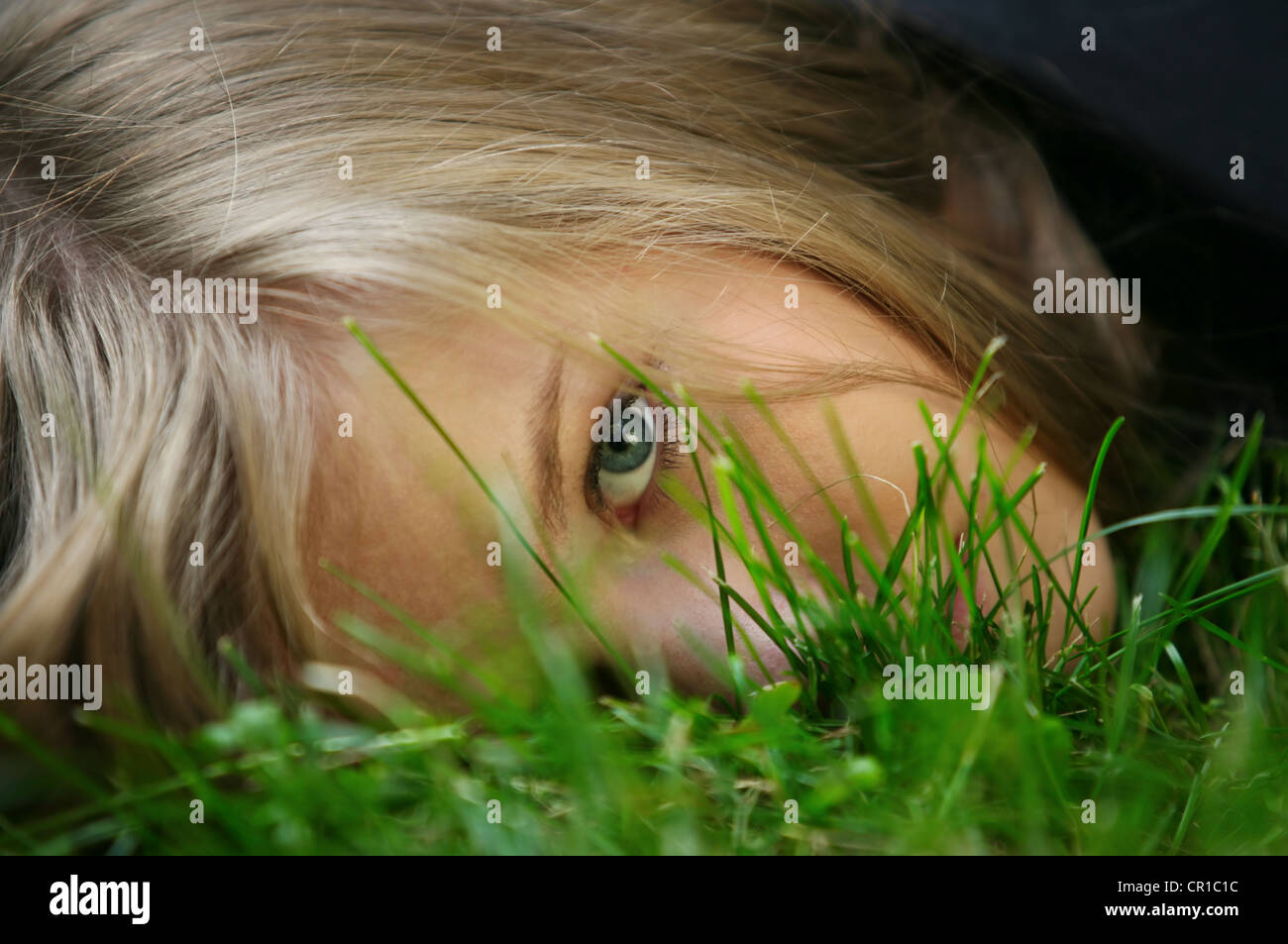 The girl in a grass. The face close-up Stock Photo - Alamy