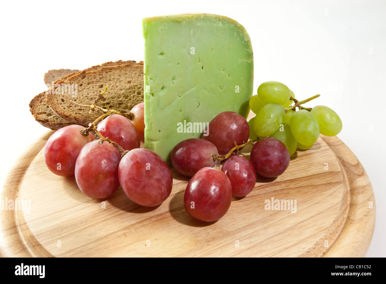 Spicy Japanese wasabi cheese on a board with grapes and bread Stock ...