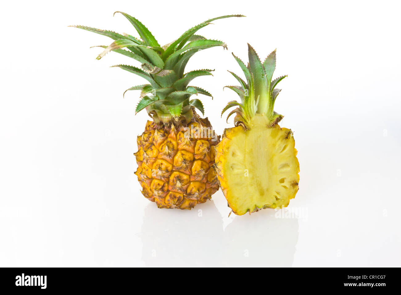 Two Pineapples (Ananas comosus), one cut in half Stock Photo - Alamy