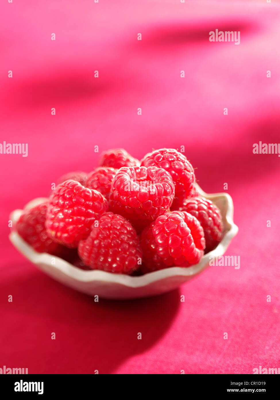 Raspberries in a small bowl Stock Photo - Alamy
