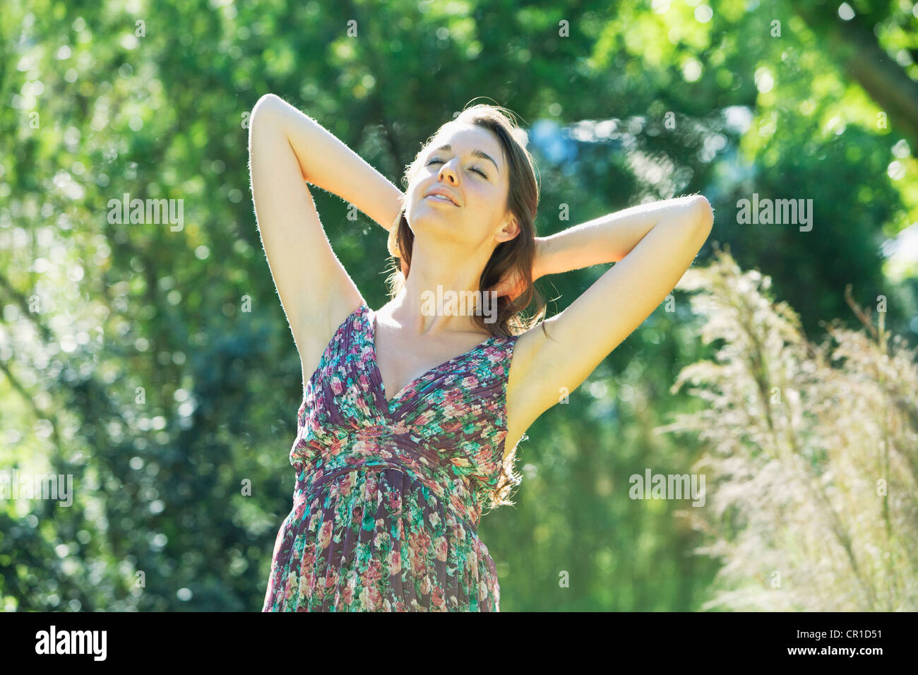 Teenage girl tossing her hair outdoors Stock Photo - Alamy