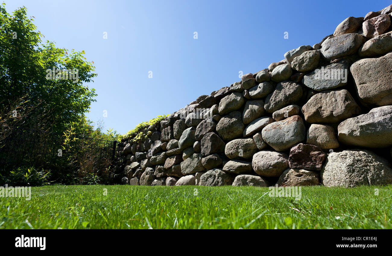 Rock wall against a blue sky Stock Photo - Alamy