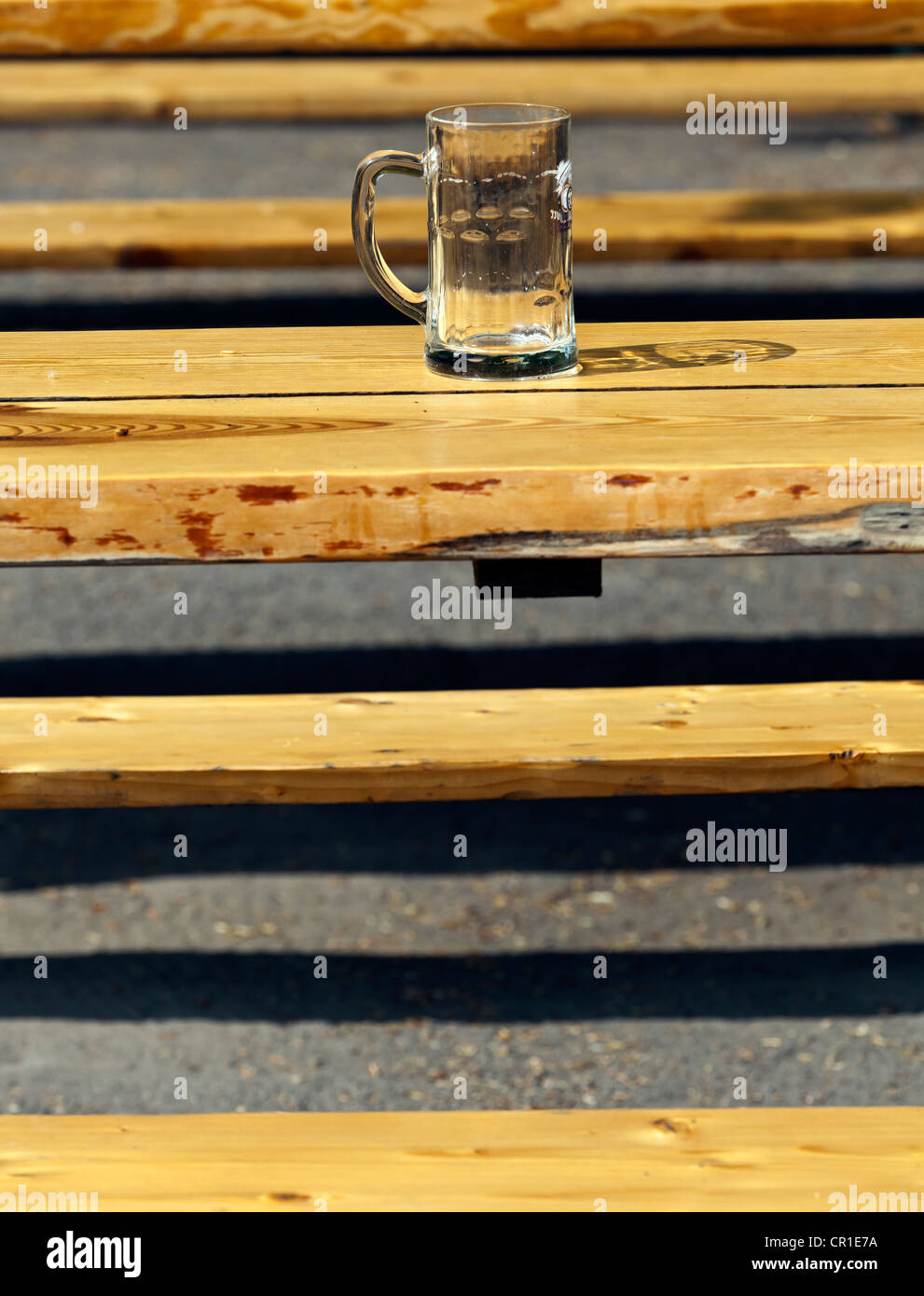 Empty beer mug on a table in a beer garden Stock Photo - Alamy