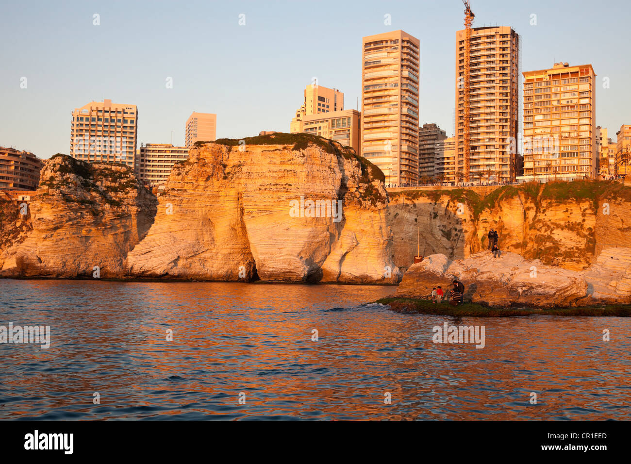 Lebanon, Beirut, Pigeon Rock and Beirut architecture at sunset Stock ...