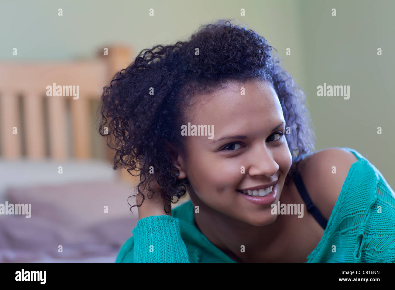 Smiling woman laying on bed Stock Photo - Alamy