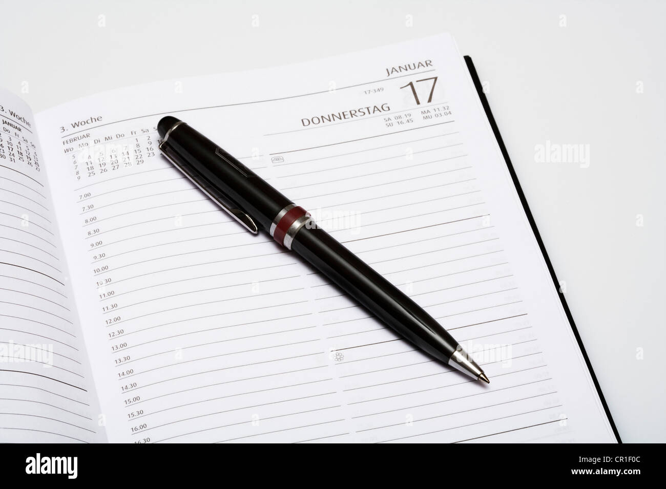 Day planner with a pen Stock Photo - Alamy