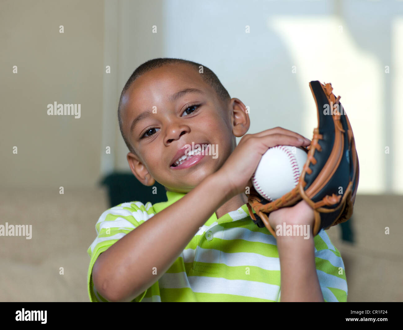 Boy holding baseball and glove Stock Photo - Alamy
