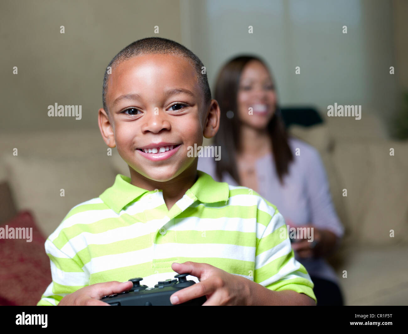 Smiling boy holding game controller Stock Photo - Alamy