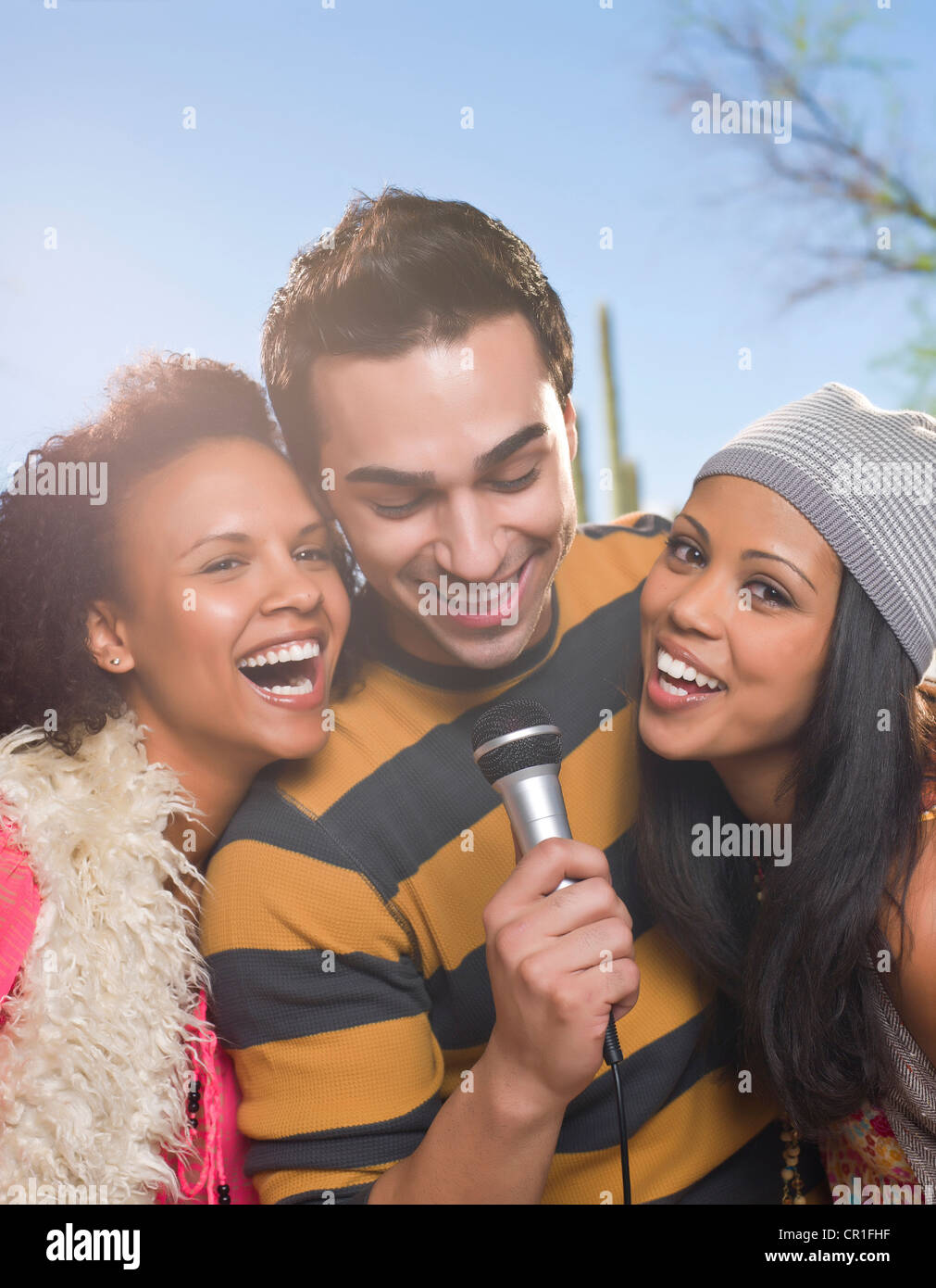 Friends singing together outdoors Stock Photo - Alamy