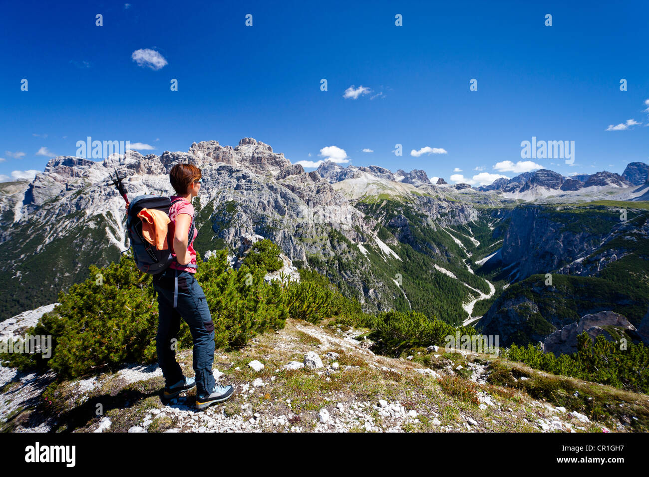 Hiker on Monte Piano overlooking the Alta Pusteria valley, with the ...