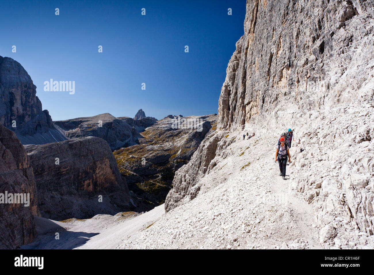 Hikers on the Alpinisteig climbing route, with the Three Peaks at the ...