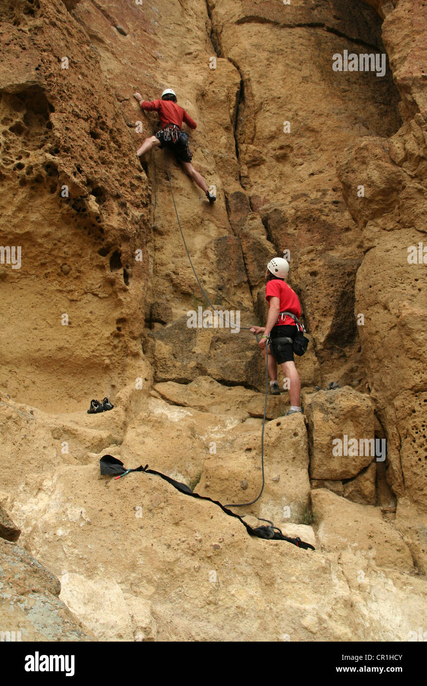 Potholes, climbers on rock face, Smith Rock State Park, Central Oregon ...