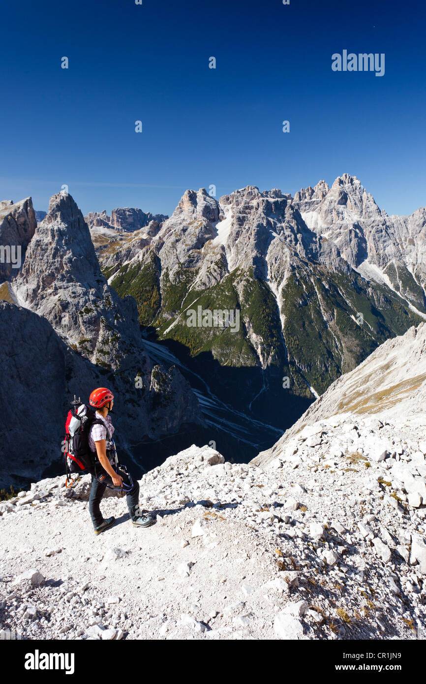 Hiker at the Strada degli Alpini via ferrata, looking towards Mt Cima ...