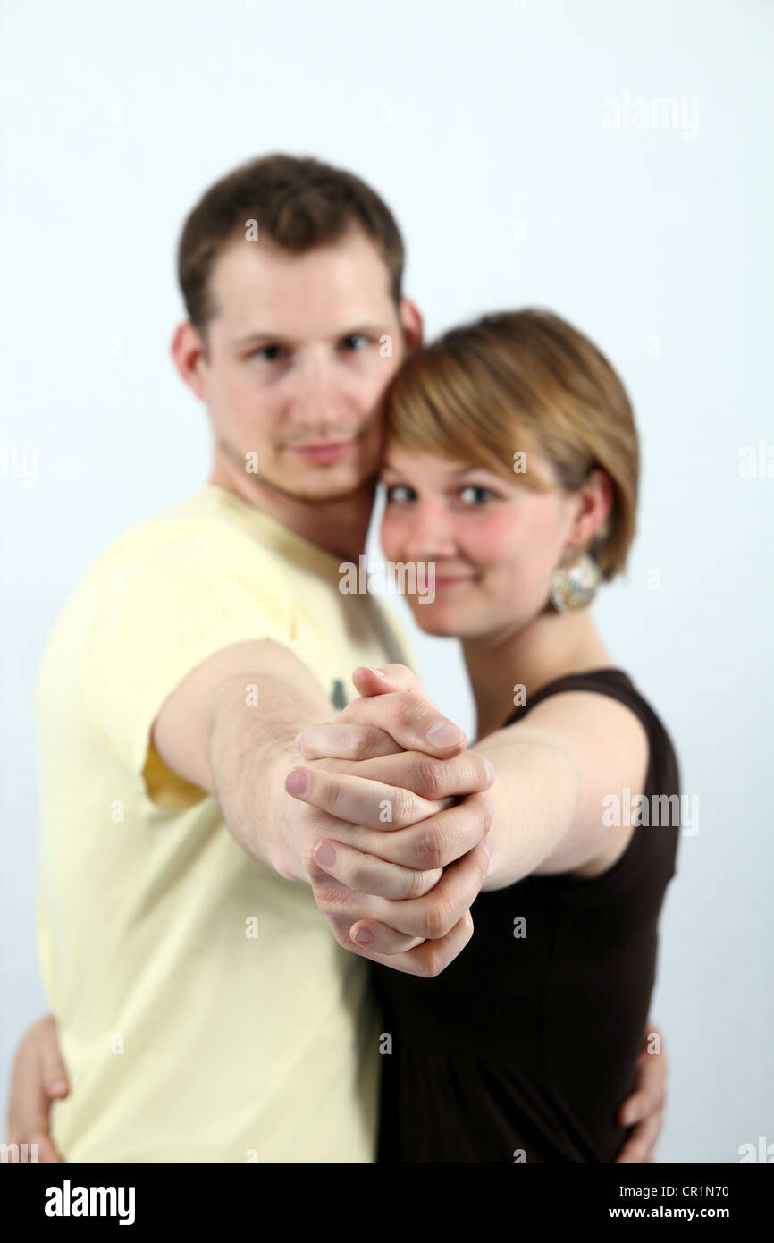 Young couple ballroom dancing with their arms extended and hands ...